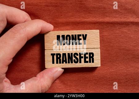 Wooden blocks with symbol of money transfer concept on blue background ...