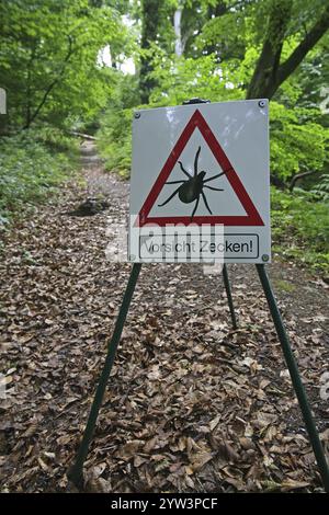 A hiker fears a tick bite, Warning sign, Caution ticks, Insects Hesse ...