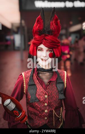 Close up of a smiling pretty girl using mobile phone while sitting at ...