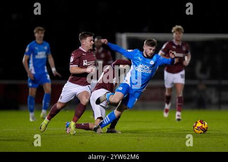 Peterborough United's Cian Hayes (right) shoots at goal during the ...