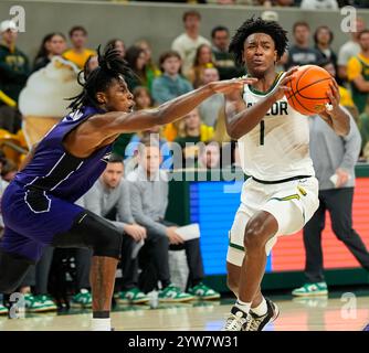Baylor guard Robert Wright III, center, is mobbed by teammates after ...
