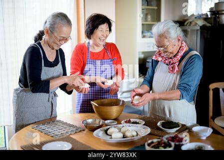 Senior woman making rice balls with a smile Stock Photo - Alamy