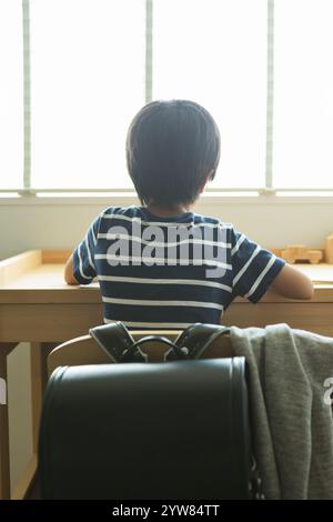 Primary schools boy studying, back view Stock Photo - Alamy