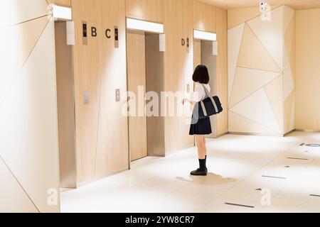 Female students waiting for the elevator Stock Photo - Alamy