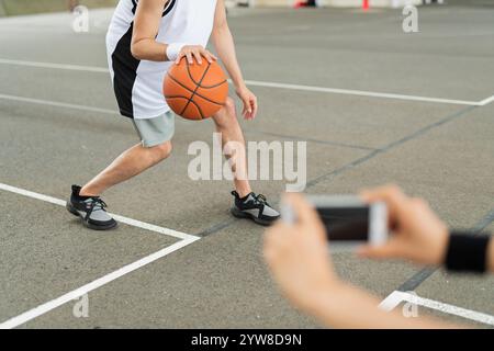 Woman recording basketball practice Stock Photo - Alamy
