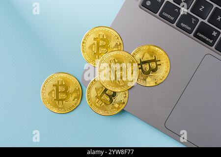 Golden bitcoin on blue background Stock Photo - Alamy