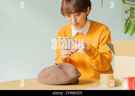 Woman taking photos of merchandise Stock Photo - Alamy