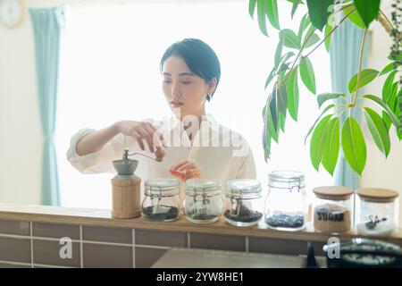 Woman making coffee before going to work Stock Photo - Alamy