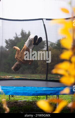 On a cloudy autumn day, the kid is playing near the window.Domestic ...