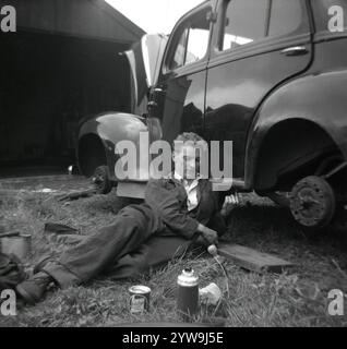 1950s, historical, a male car mechanic and female clerk of the Hargood ...