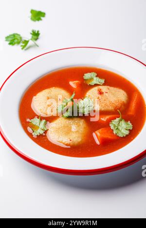 Traditional Jewish tomato soup with matza meatballs, white background ...