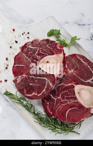 raw veal meat with marrow bone for italian dish Osso Buco on wooden ...