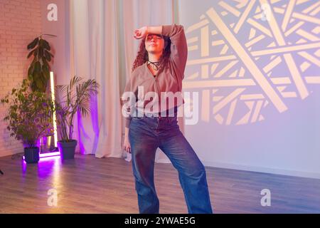 Modern dancer poses in front of the gray studio background. Modern ...