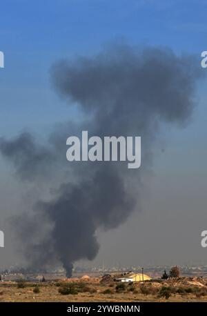 Damascus, Syria. 9th Dec, 2024. Smoke rises following an Israeli ...
