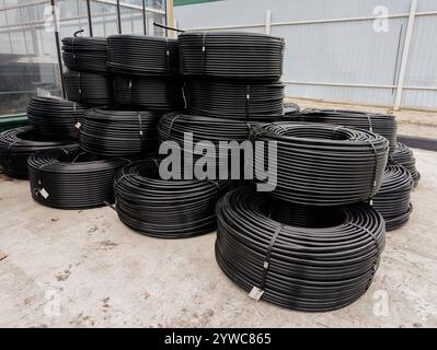 Rolled up black construction wire Stock Photo - Alamy