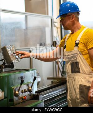 Skilled metalworker operating a lathe machine, producing precision ...