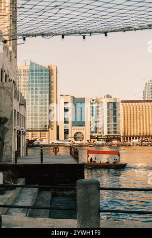 The cityscape of historic Al Seef neighborhood with adobe houses, barjeel windcatchers, tourist ...