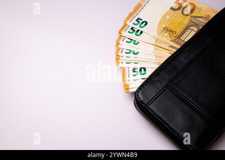 Black leather wallet with fifty euro bills banknotes on white ...
