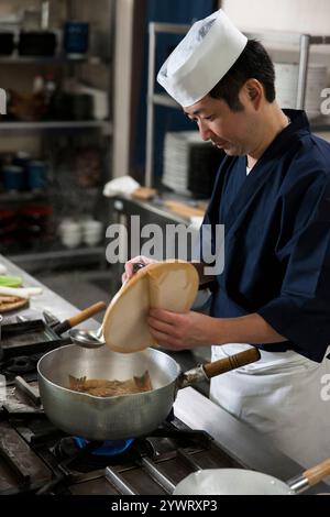 Cook with fallen lid and ladle Stock Photo - Alamy