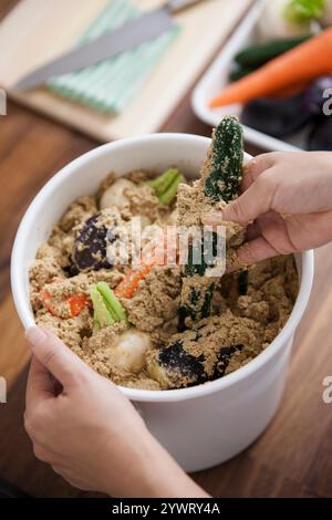 Woman soaking vegetables in bran Stock Photo - Alamy