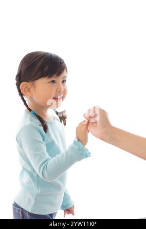 Girl promising to cut her finger with her mother Stock Photo - Alamy