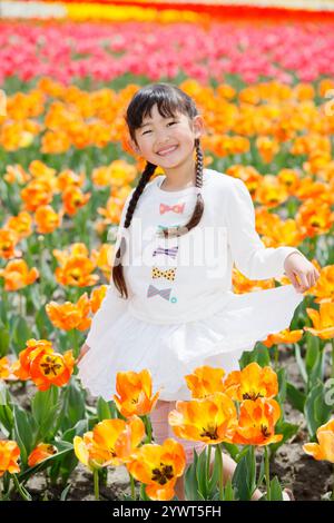 Girl laughing in tulip field Stock Photo - Alamy