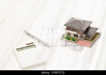 Miniature house and floor plan, calculator Stock Photo - Alamy