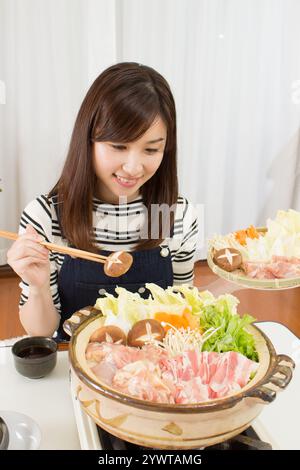 Young Woman Eating Japanese Cuisine Stock Photo - Alamy