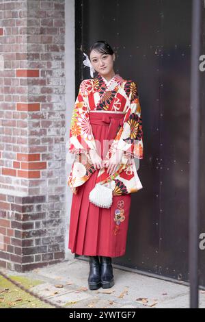 young pretty geisha in black kimono among sakura, asian ethno closeup ...
