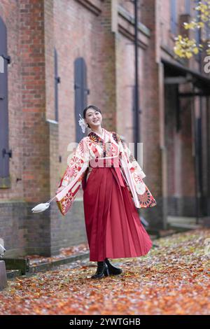 young pretty geisha on red background posing in kimono, oriental Stock ...