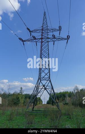 rows of power pylons running through picturesque fields Stock Photo - Alamy