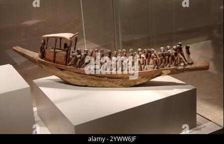 Model of a funerary boat with oarsmen and a sarcophagus under a canope ...
