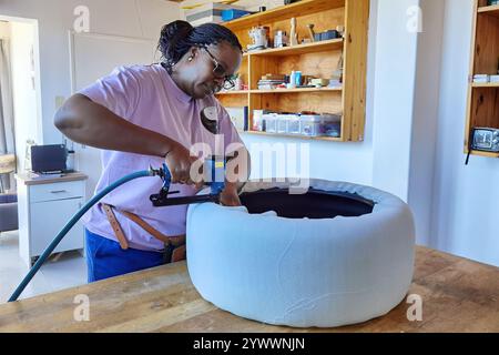 Windhoek, Namibia. 5th Dec, 2024. Samueline Uapingene-Masule (L) works ...