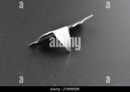 Unusual metal things, a metal fragment for canned food is located on a ...