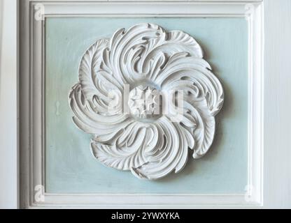 White stucco plafond decoration over green backdrop. Classic wall ...
