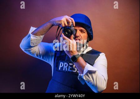 Reporter in bulletproof vest with a camera Stock Photo - Alamy