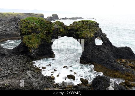 Arnarstapi cliffs with birds colonies. Natural arch and window ...