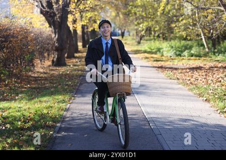 Happy mailman on bicycle outdoors. Postal service Stock Photo - Alamy