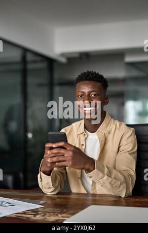 Portrait, smile and a black man employee on stairs in the office on his ...