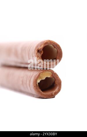 Waffle rolls coated chocolate. Close up. White background Stock Photo ...