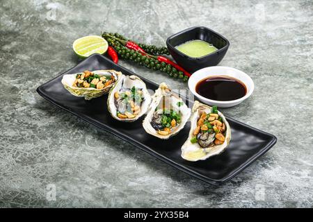 Open half oysters with green onion and peanut Stock Photo - Alamy