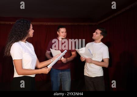 Professional actors with their scripts rehearsing in theatre Stock ...