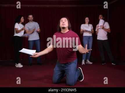 Professional actors with their scripts rehearsing in theatre Stock ...