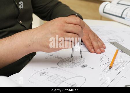 Engineer working with project, closeup. Different technical drawings on white table Stock Photo ...