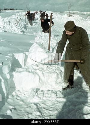 Soldiers of the 110th Infantry Division work on clearing snow from the ...