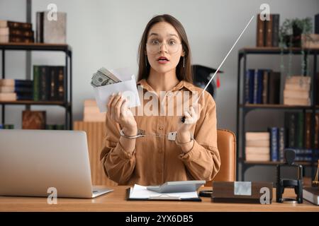 Female teacher with bribe and pointer in classroom, closeup. Corruption ...