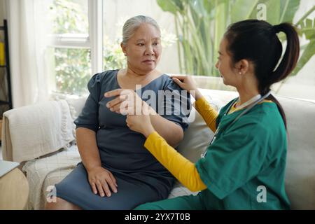 Asian woman medical professional talking phone while reading document ...