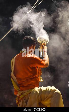 Pujaris or Indian priests performing Aarti ceremony on banks of Ganges ...