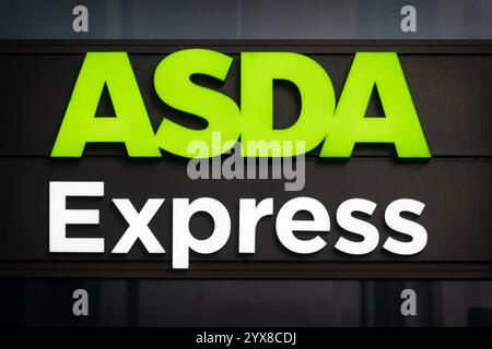 Sign and logo of a U Express supermarket. U Express is a brand of ...