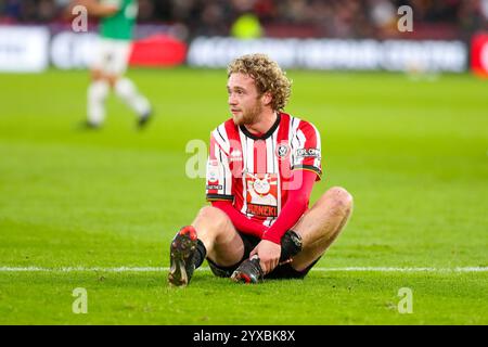 Tom Davies of Sheffield United holds off Victor Adeboyejo of Mansfield ...